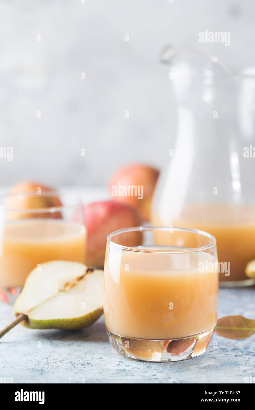 Fresh Pear Juice in a glasses with fresh fruits on light background ...