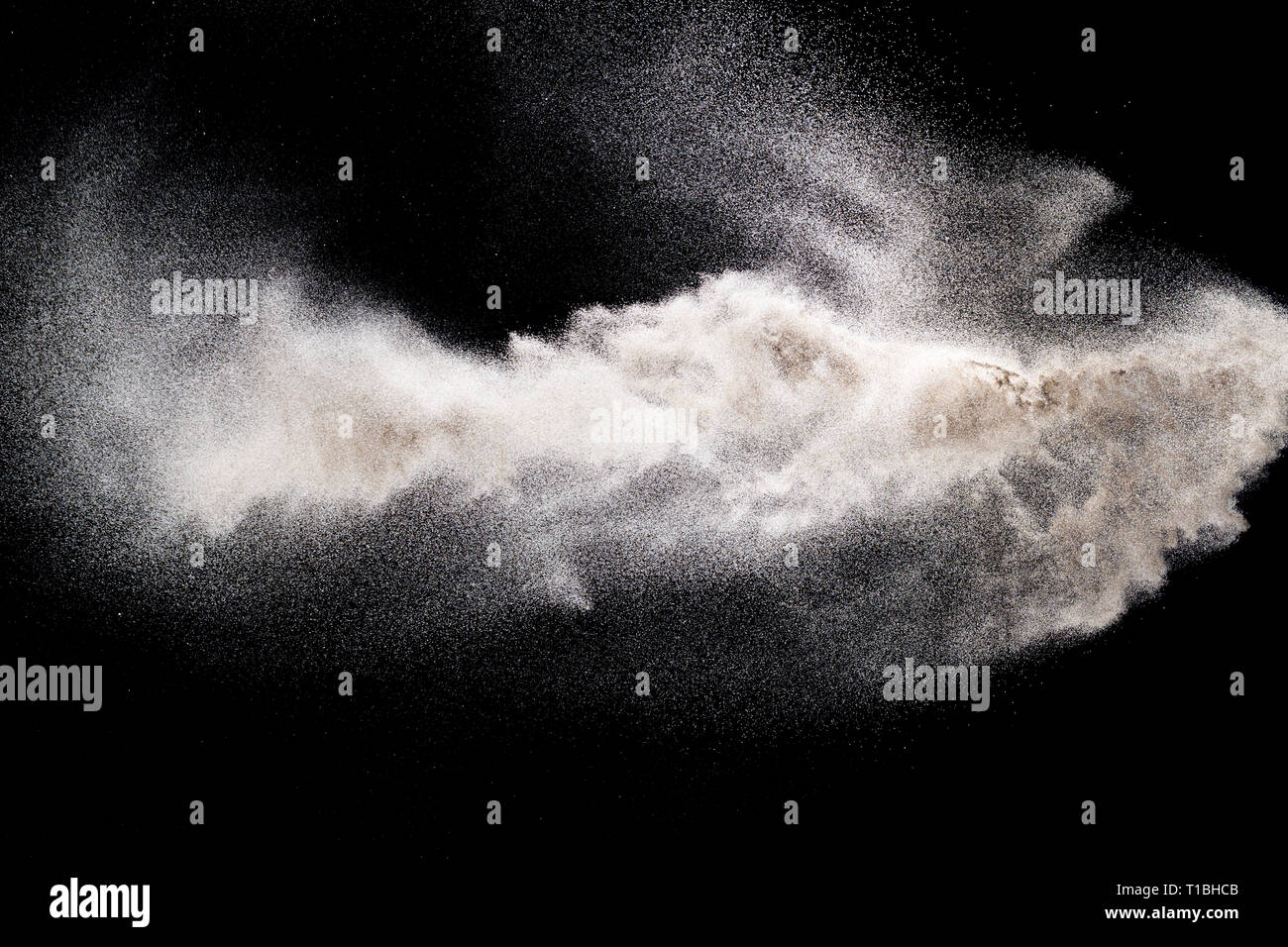 White powder explosion.Freeze motion of white dust particles on black ...