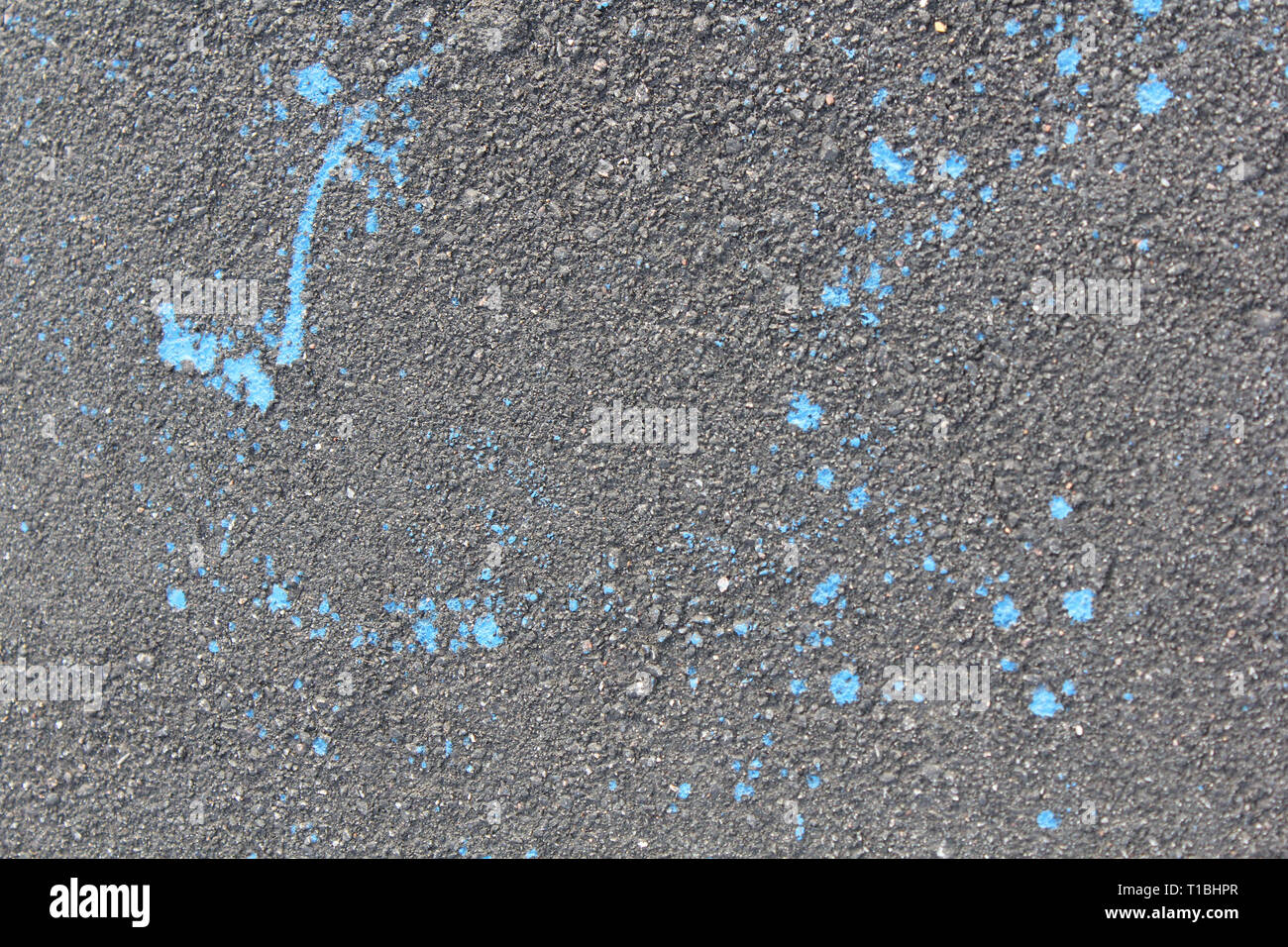 Blue paint is poured on asphalt. Abstract background Stock Photo - Alamy