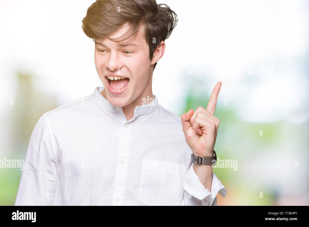 Young handsome business man over isolated background with a big smile ...