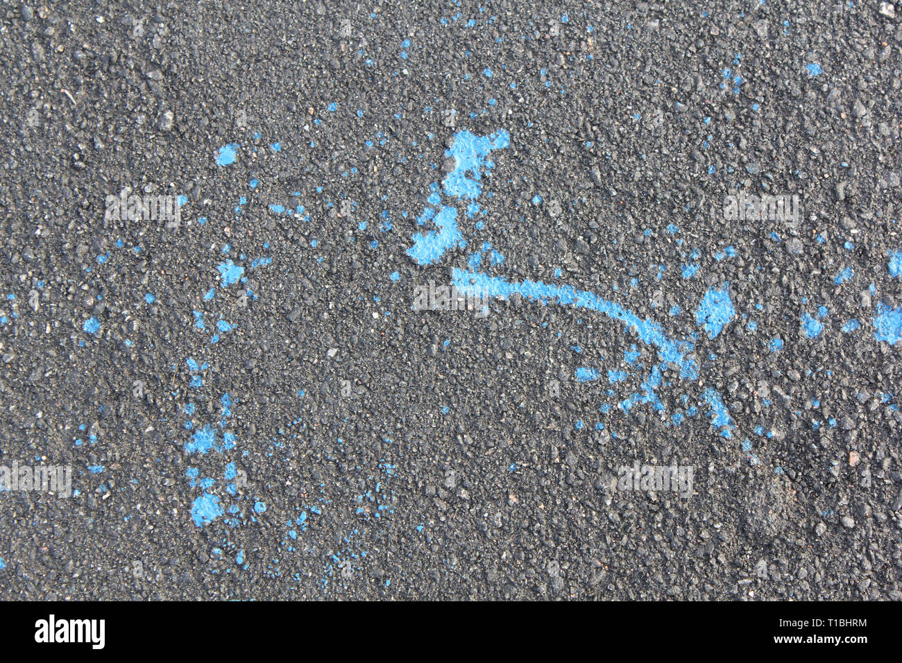 Blue paint is poured on asphalt. Abstract background Stock Photo - Alamy