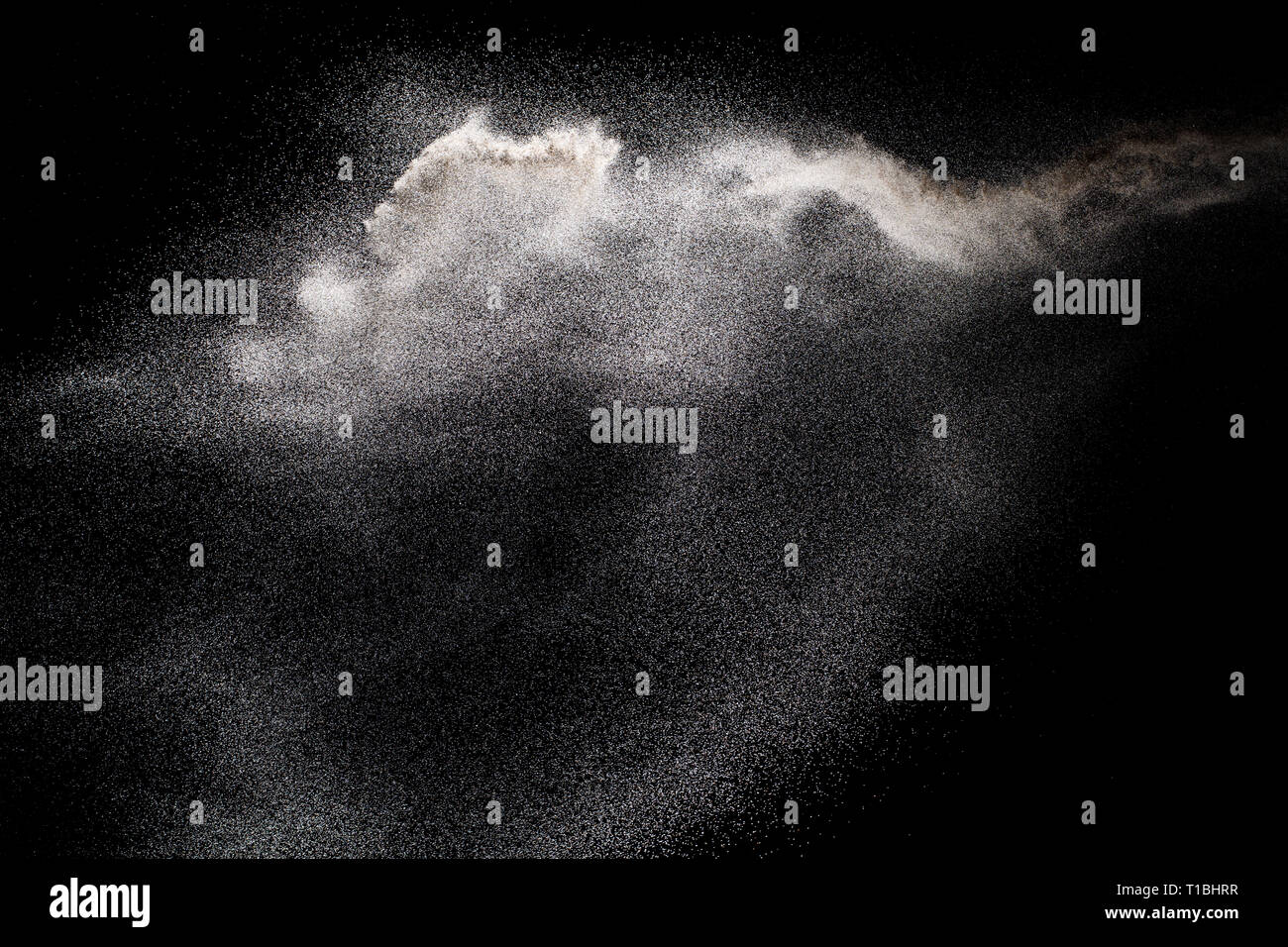 White powder explosion.Freeze motion of white dust particles on black ...