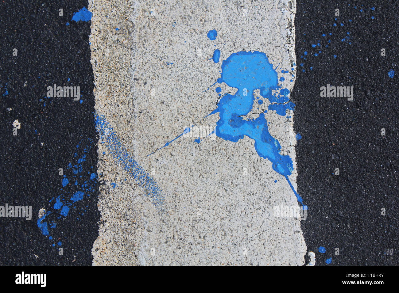 Blue paint is poured on asphalt. Abstract background Stock Photo - Alamy