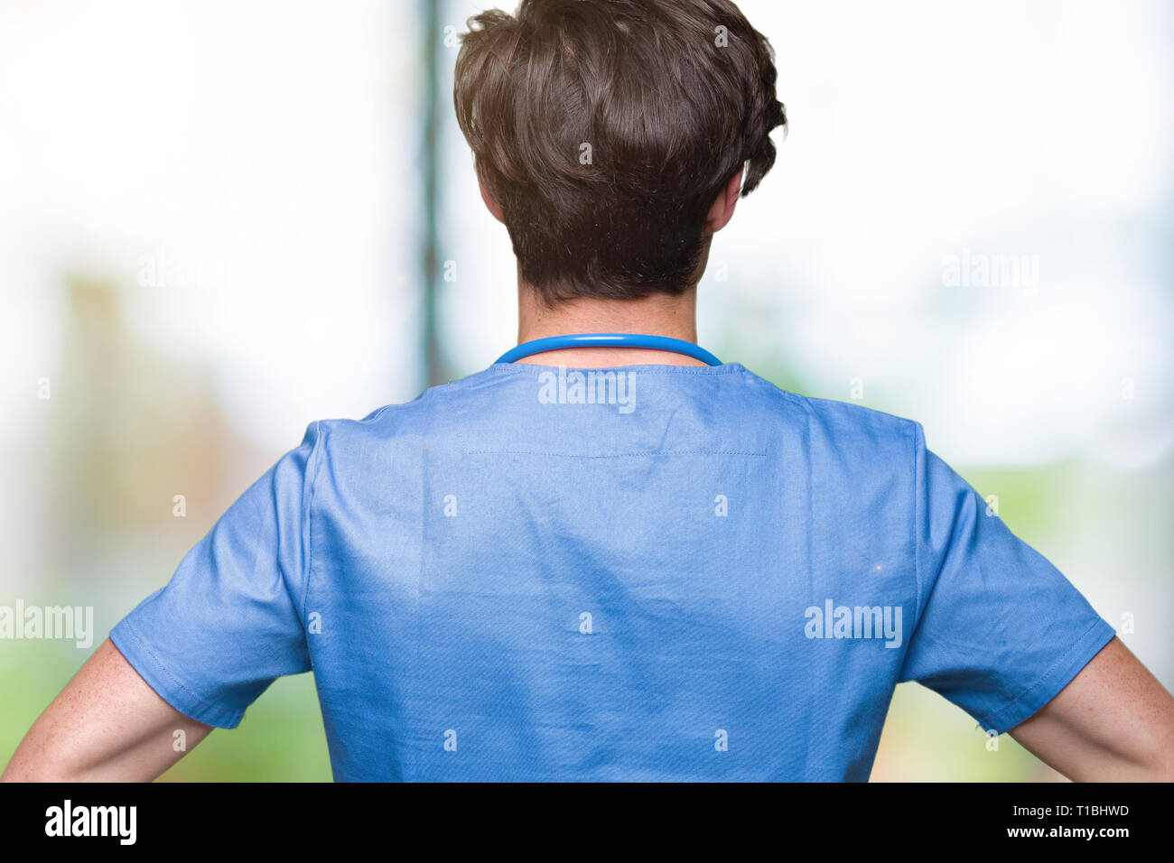 Young doctor wearing medical uniform over isolated background standing ...