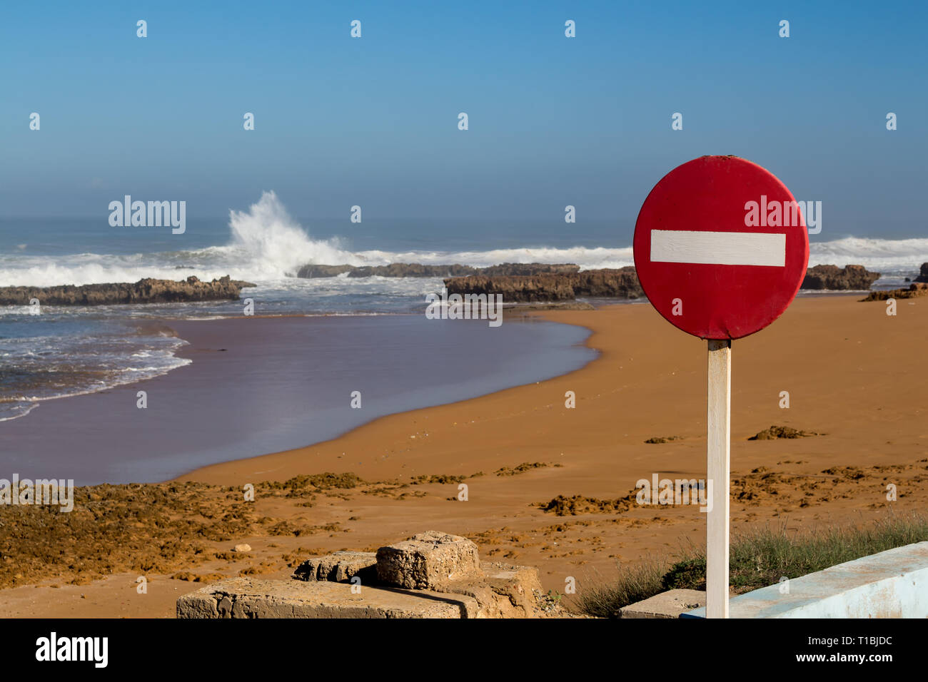 No entry traffic sign at the entrance to the beach with golden sand ...