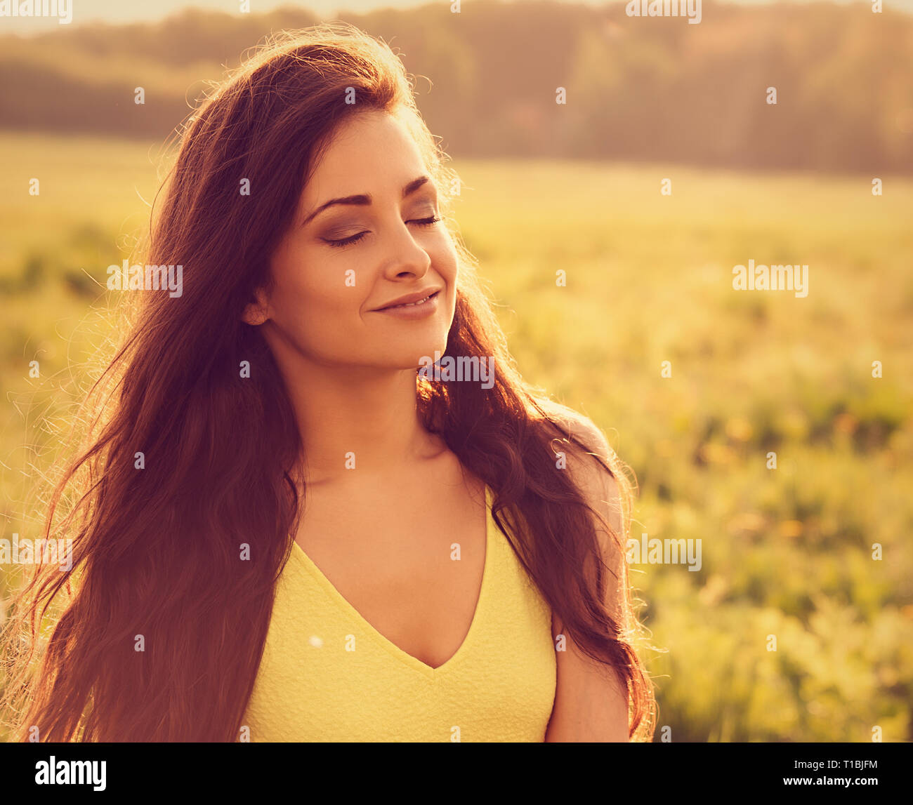 Beautiful relaxing woman with closed eyes is deep breathing and ...