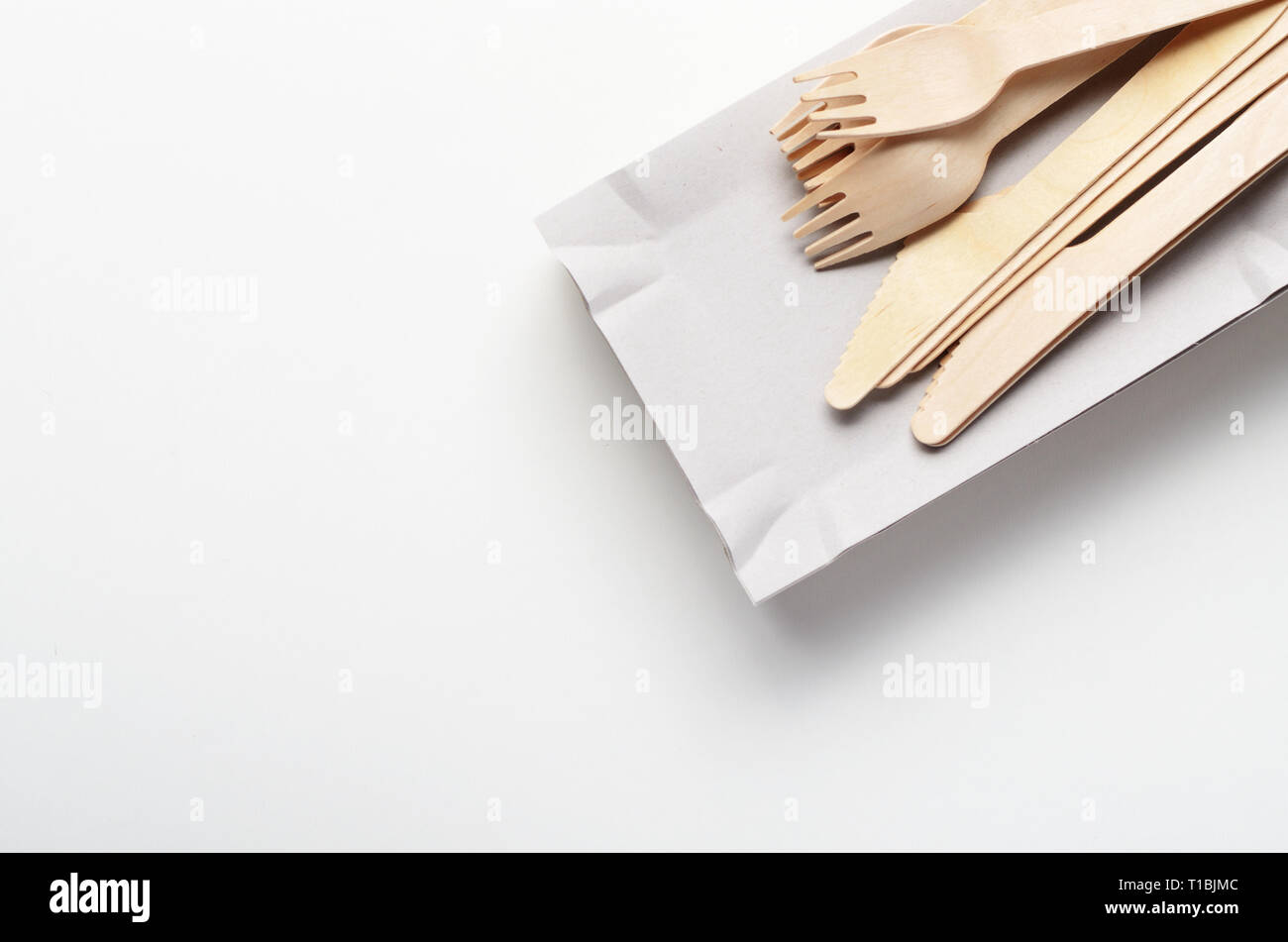Wooden single use kitchenware and paper plate on white background ...