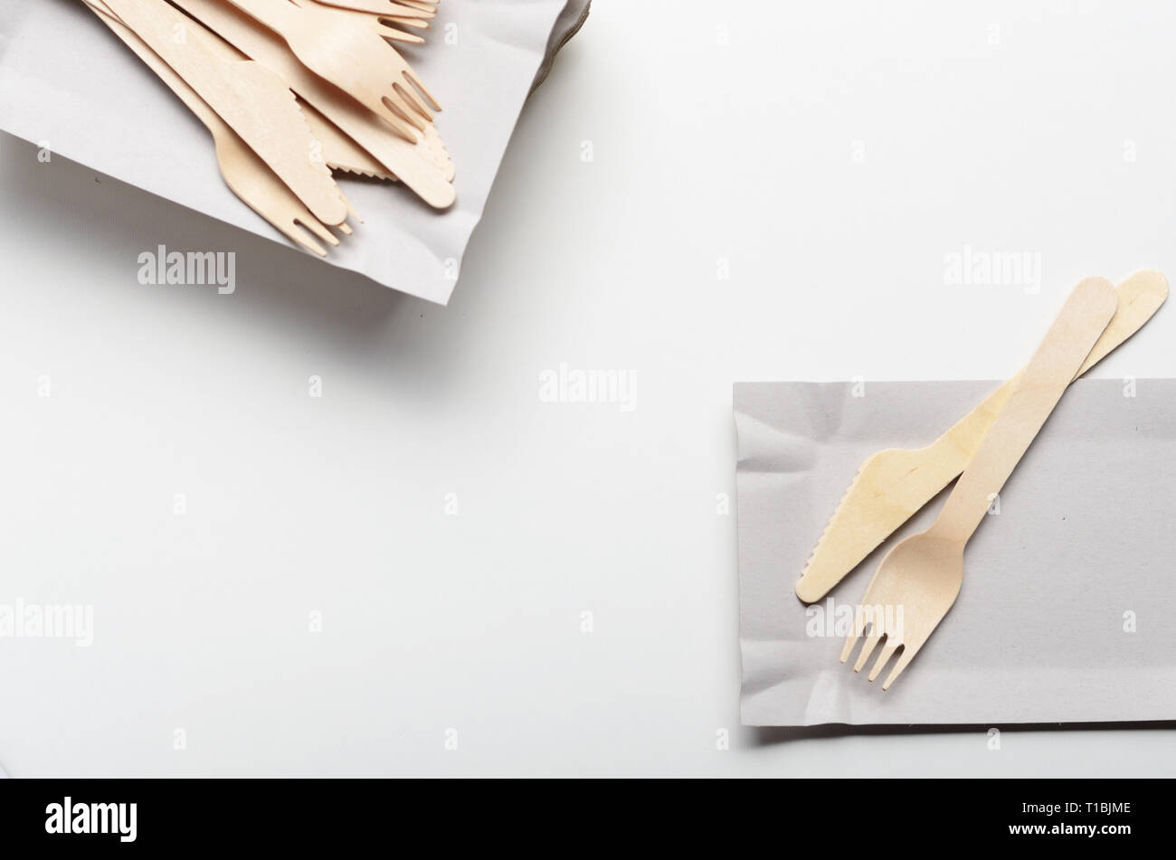 Wooden single use kitchenware and paper plate on white background ...