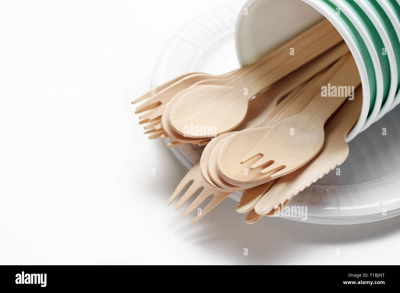 Wooden single use kitchenware and paper cups and plates on white Stock ...