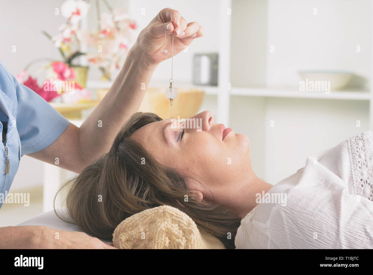 Alternative medicine therapist using pendulum to make a diagnosis Stock ...