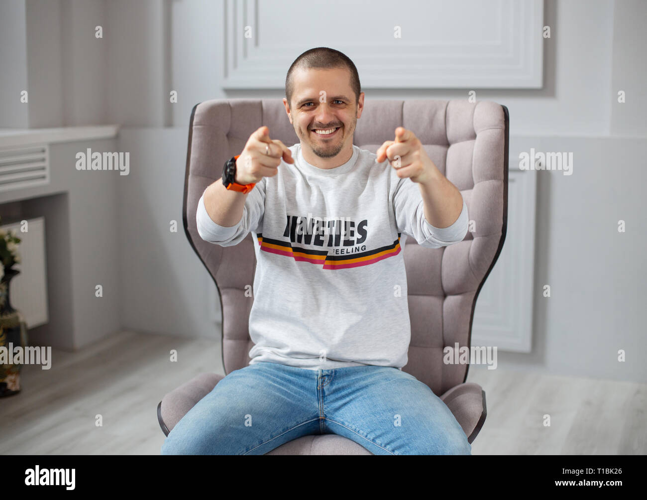 Man pointing camera sitting in hi-res stock photography and images - Alamy