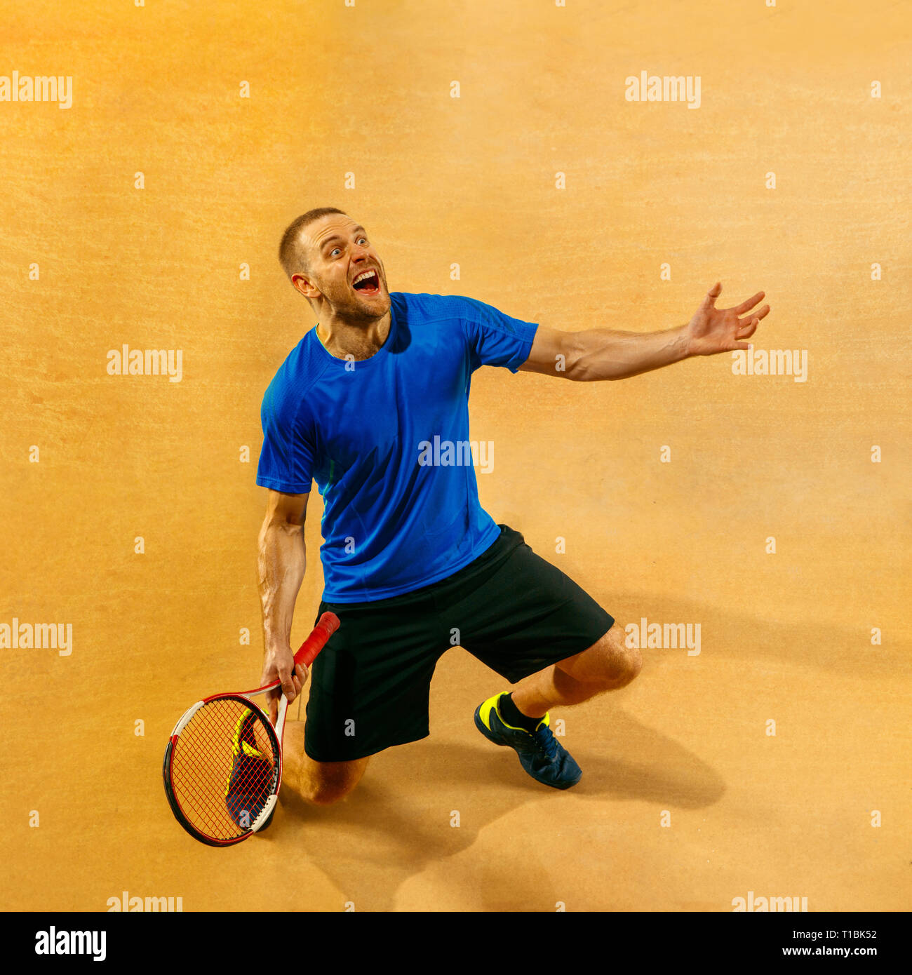 Portrait of a handsome male tennis player celebrating his success on a ...