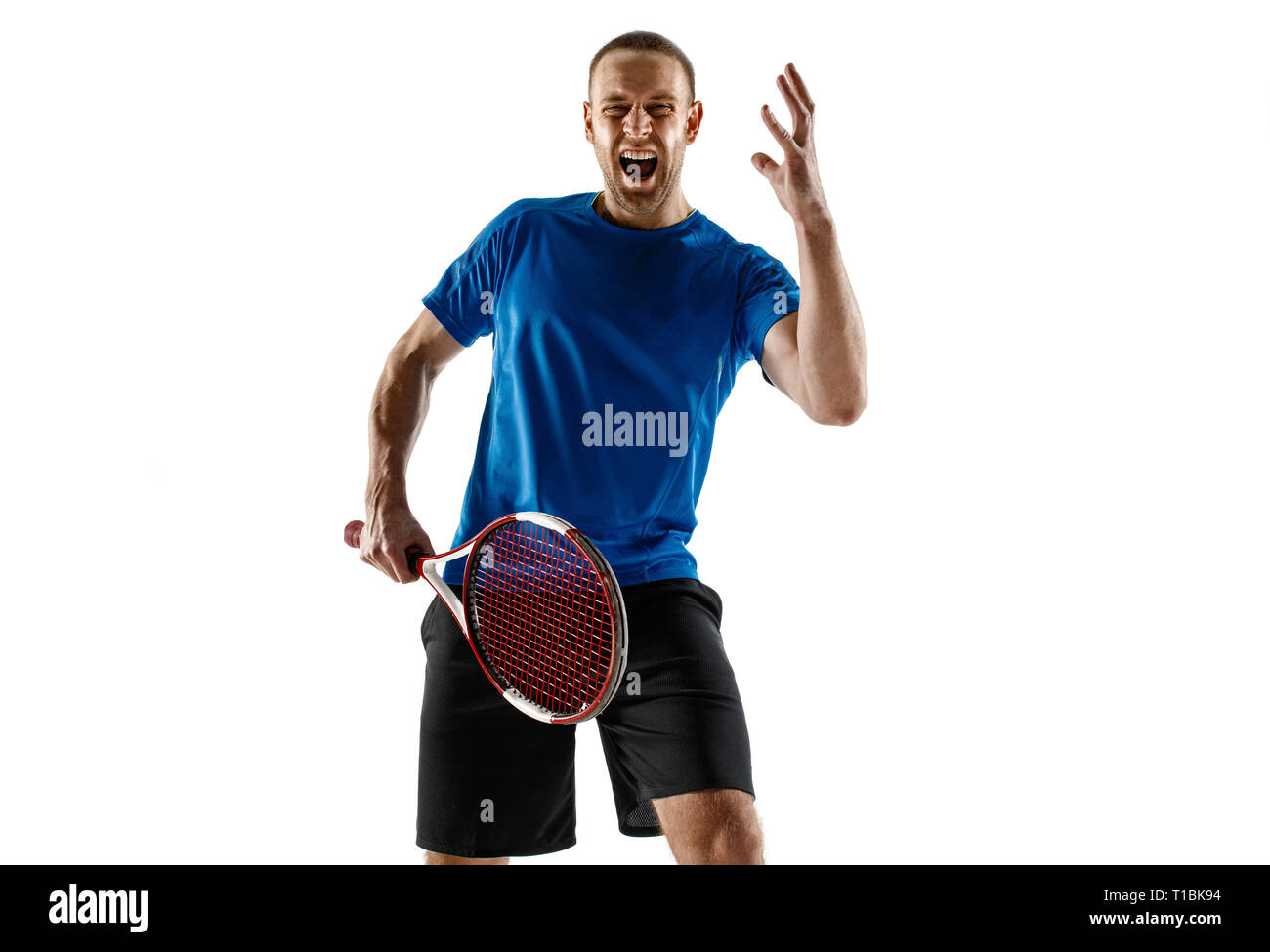 Portrait of a handsome male tennis player celebrating his success ...