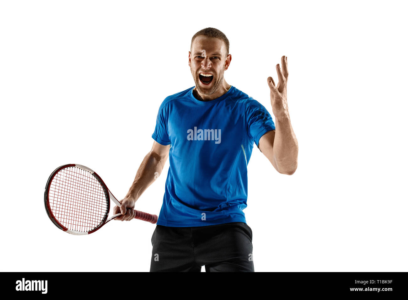 Portrait of a handsome male tennis player celebrating his success ...