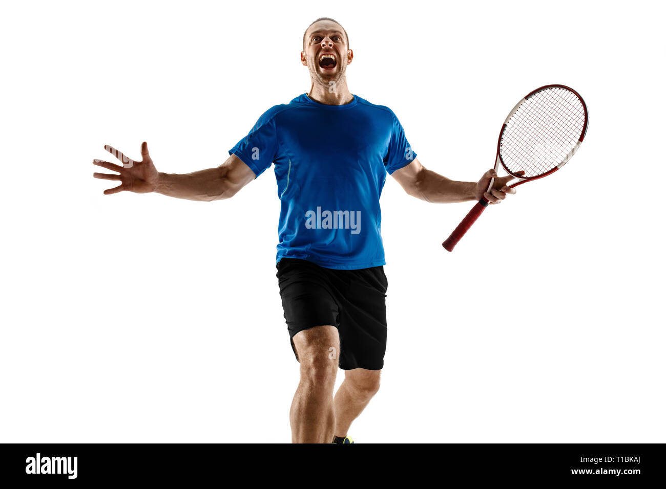 Portrait of a handsome male tennis player celebrating his success ...