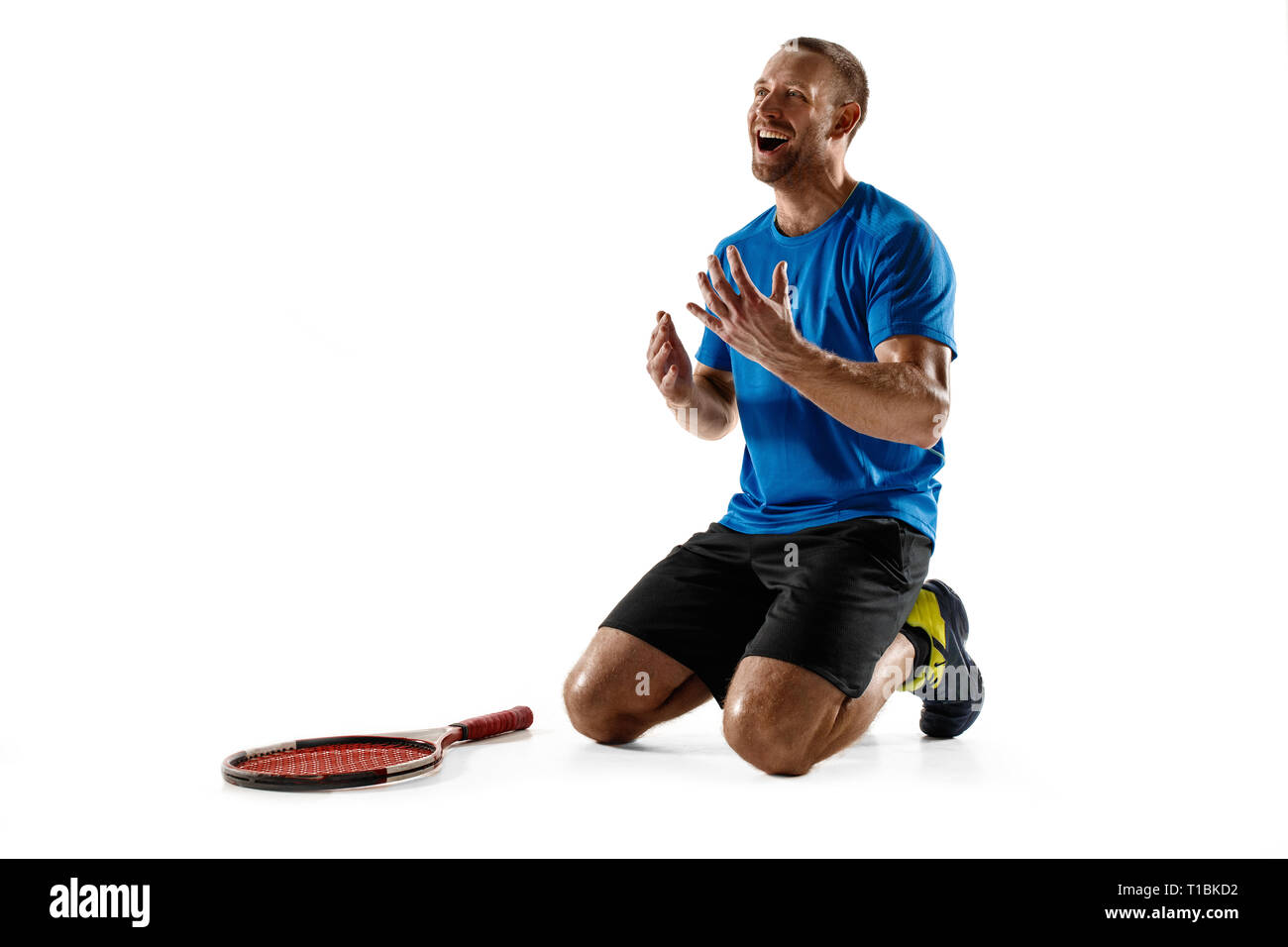 Portrait of a handsome male tennis player celebrating his success ...
