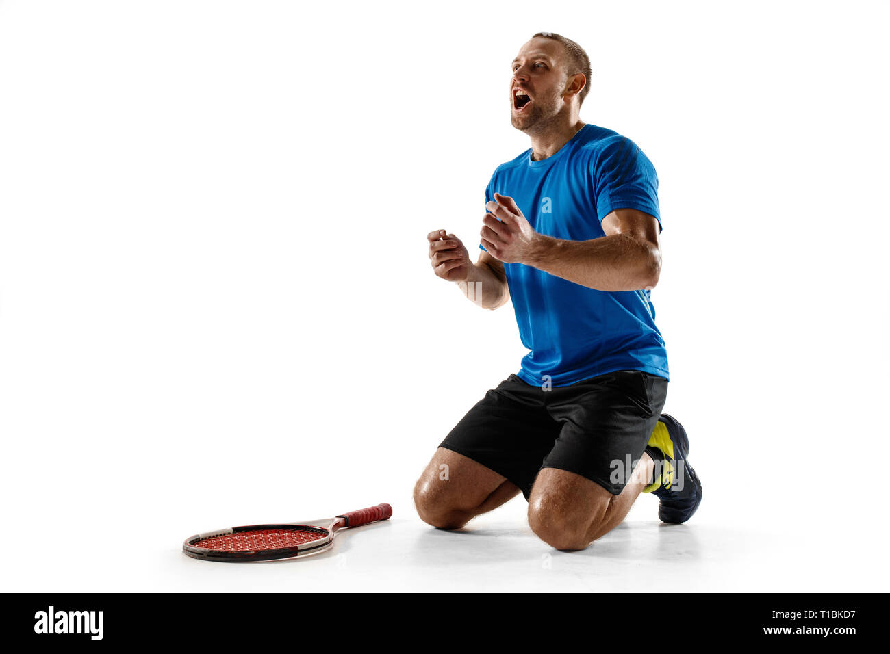 Portrait of a handsome male tennis player celebrating his success ...