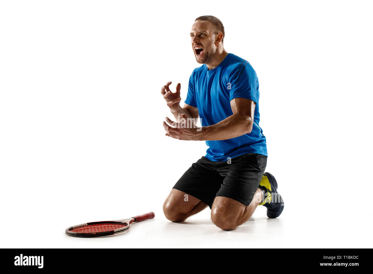 Portrait of a handsome male tennis player celebrating his success ...