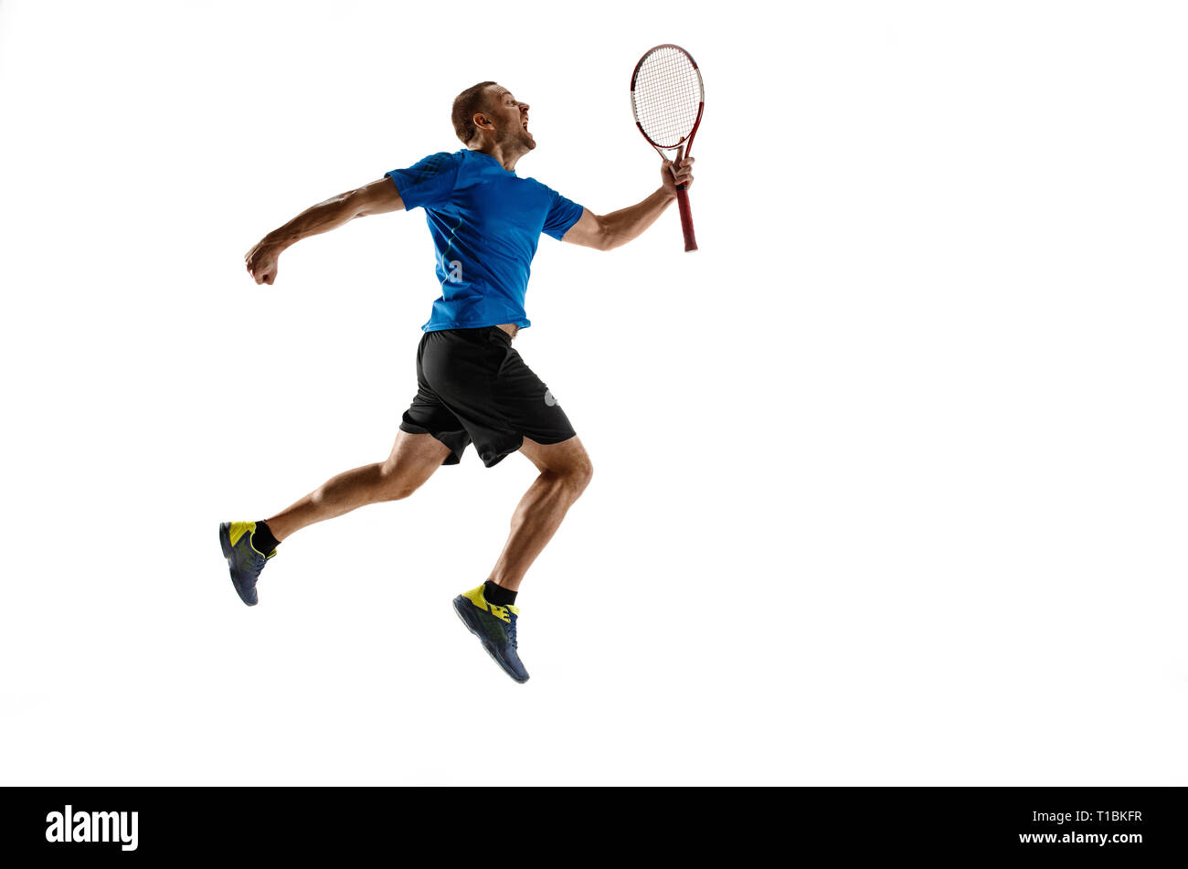 Portrait of a handsome male tennis player celebrating his success ...