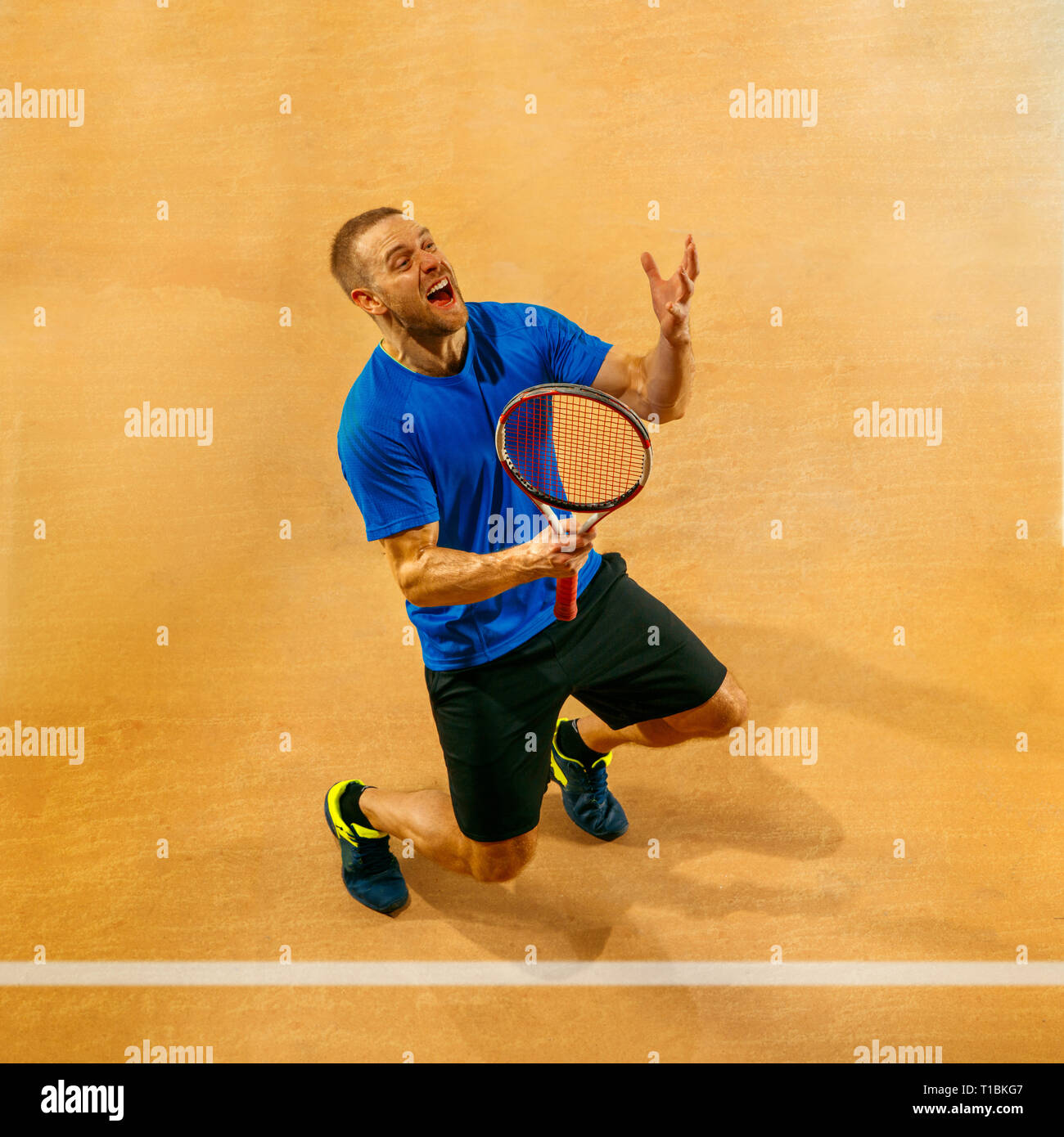 Portrait of a handsome male tennis player celebrating his success on a ...