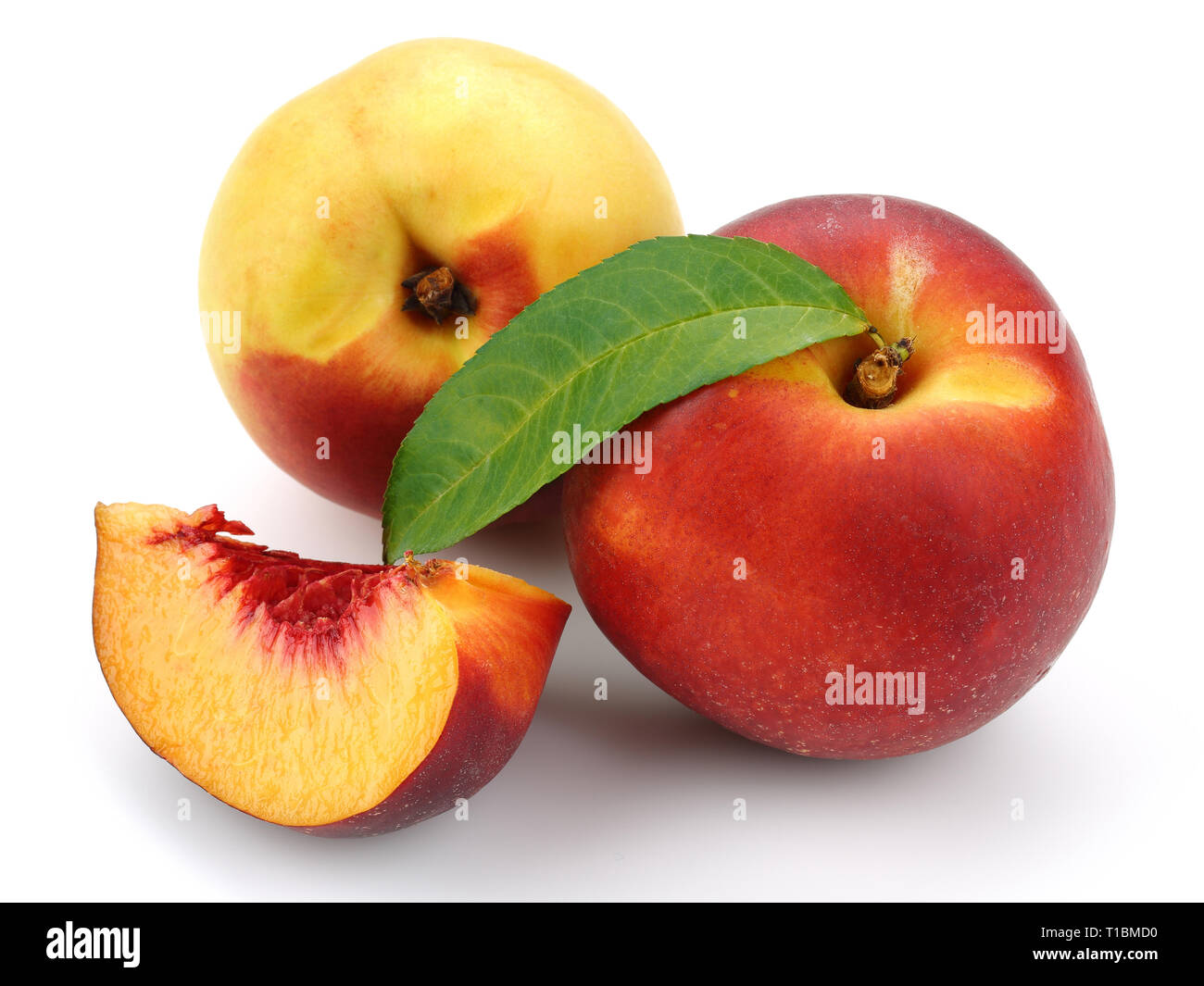 Nectarine peaches with slice and leaf isolated on white background Stock Photo - Alamy
