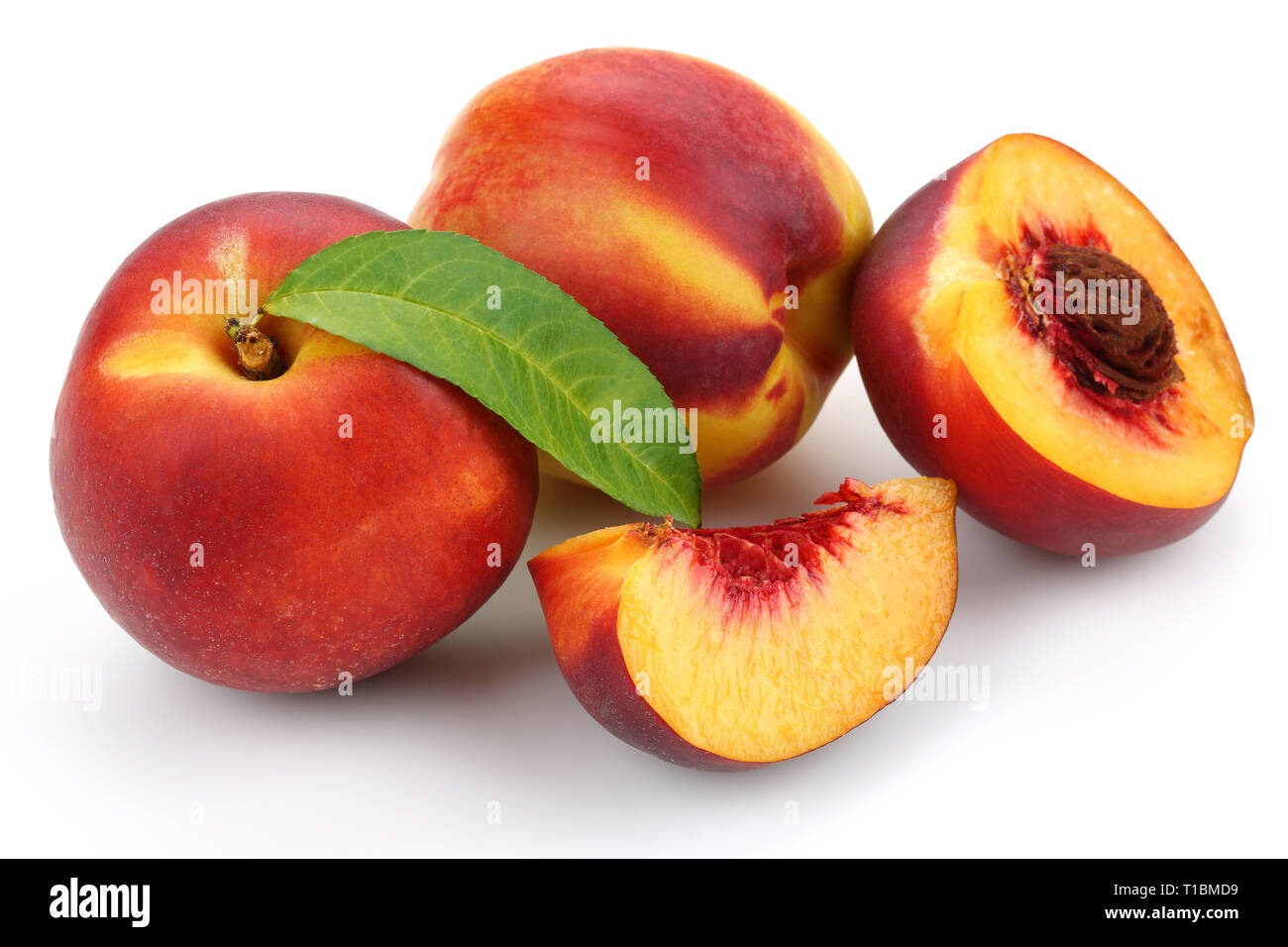 Nectarine peaches with slice and leaf isolated on white background Stock Photo - Alamy