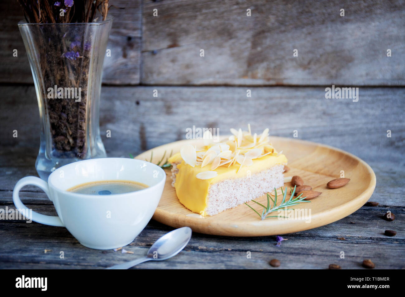 Coffee cup and cake on table at wall background Stock Photo - Alamy