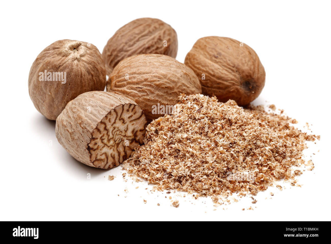 Whole and grated nutmeg isolated on white background Stock Photo - Alamy