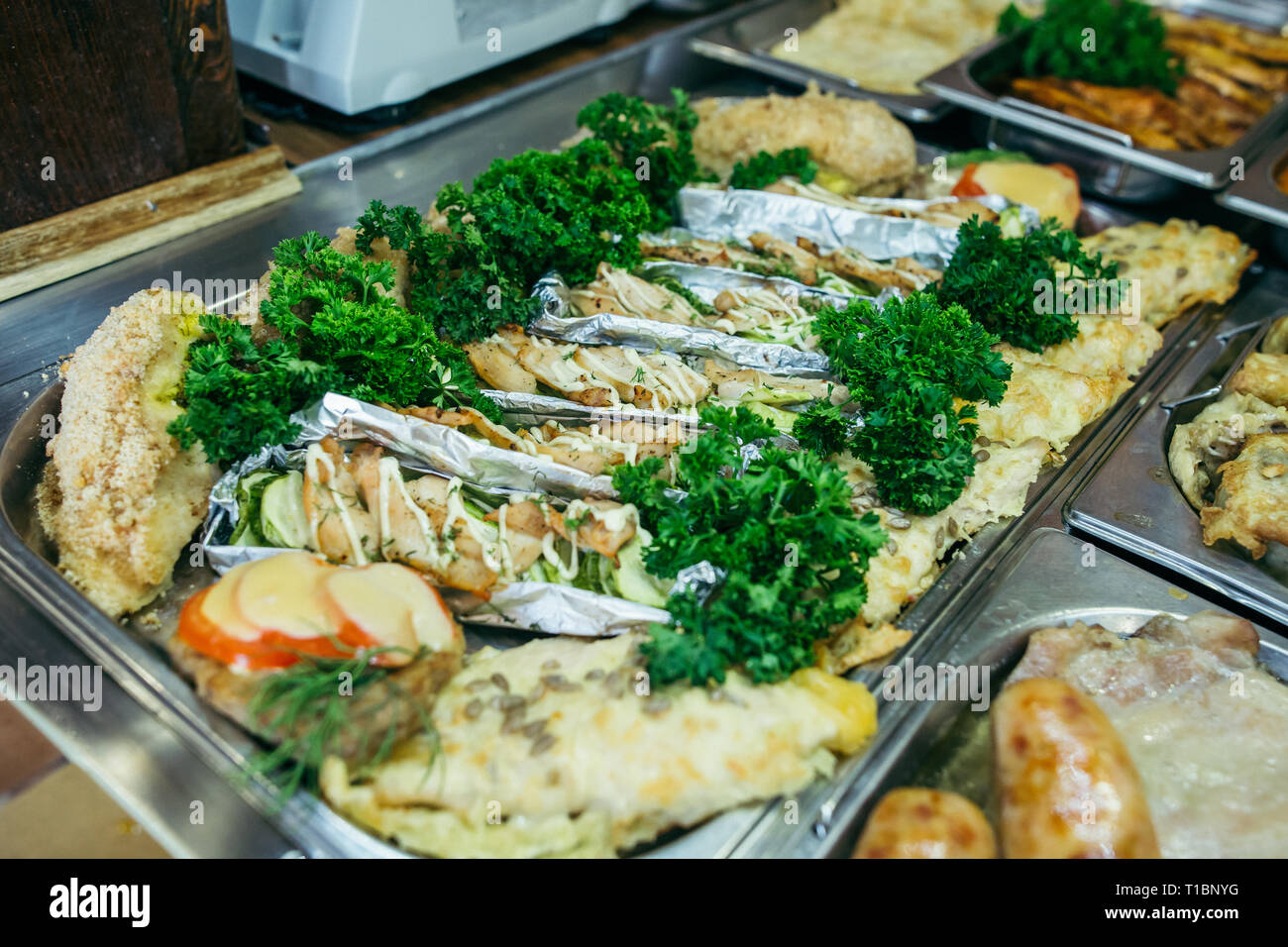 A set of meat dishes in the trays, a banquet table Stock Photo - Alamy