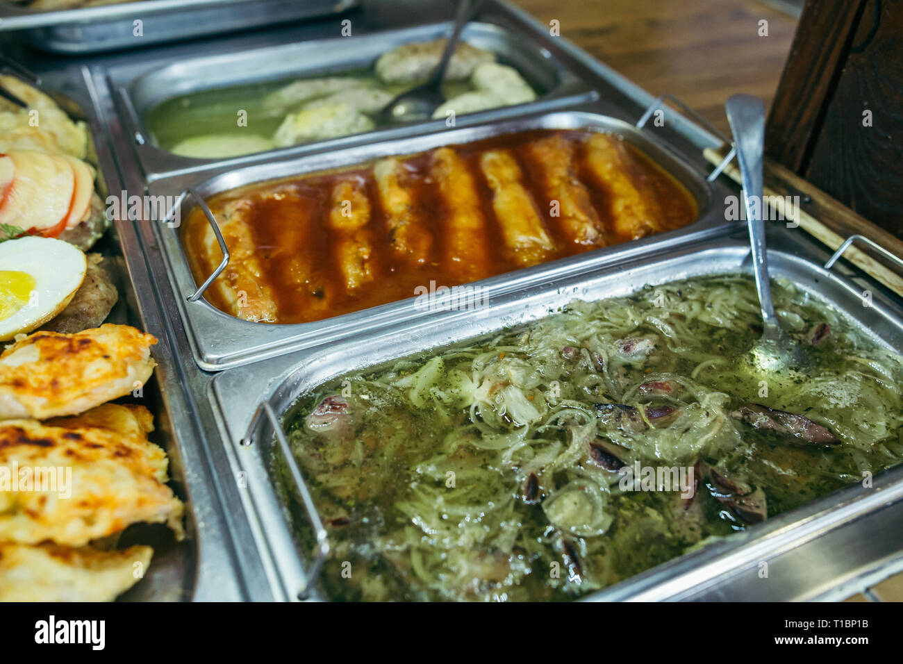A set of meat dishes in the trays, a banquet table Stock Photo - Alamy