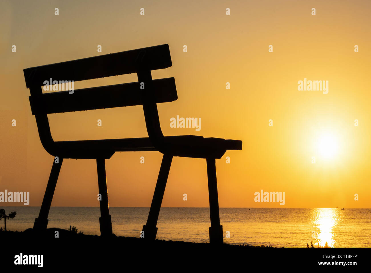 Silhouette of a bench against sea sunset Stock Photo - Alamy