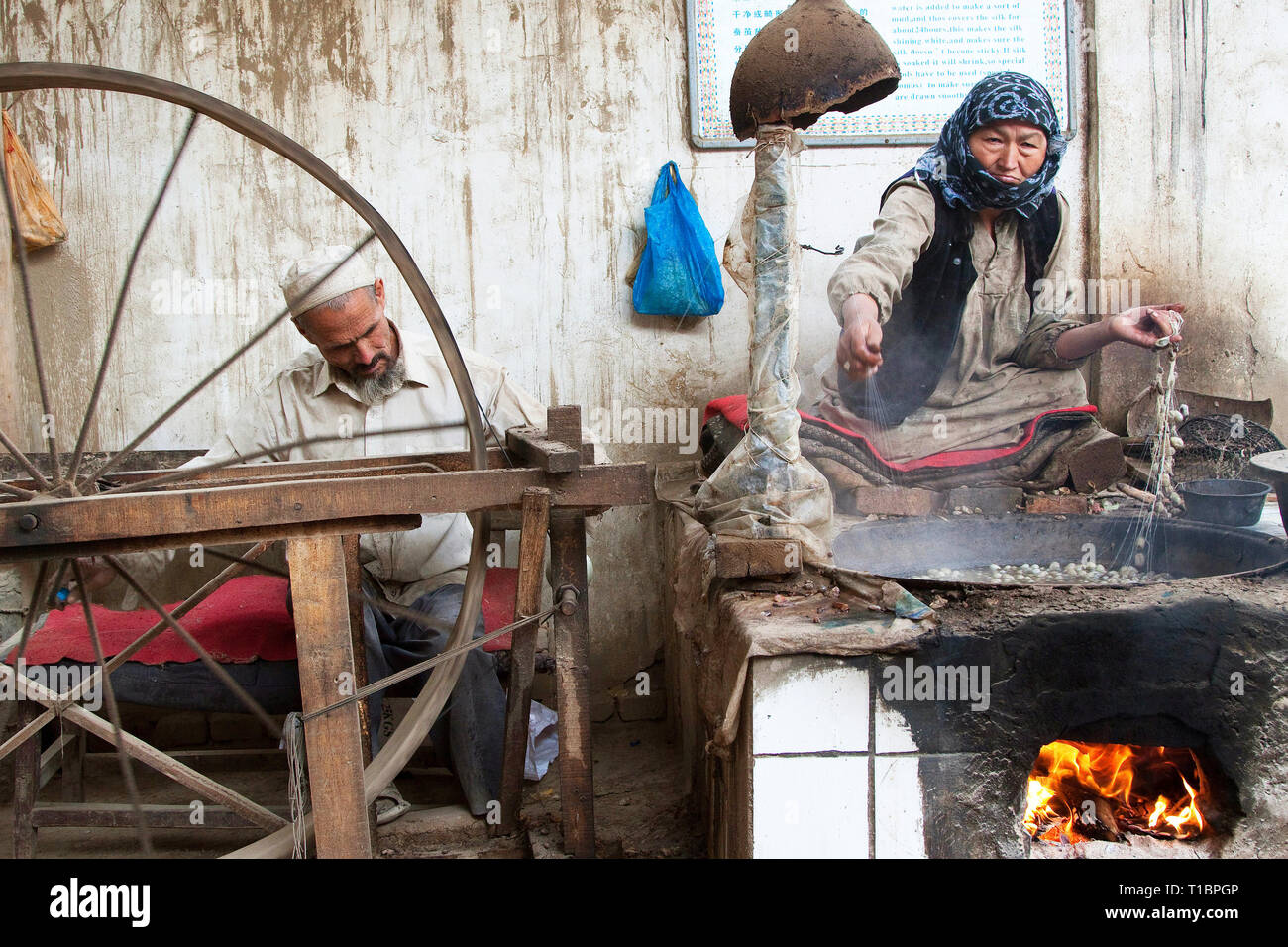 Old technique of spinning silk. Silk worm cocoons are boiled in a large ...