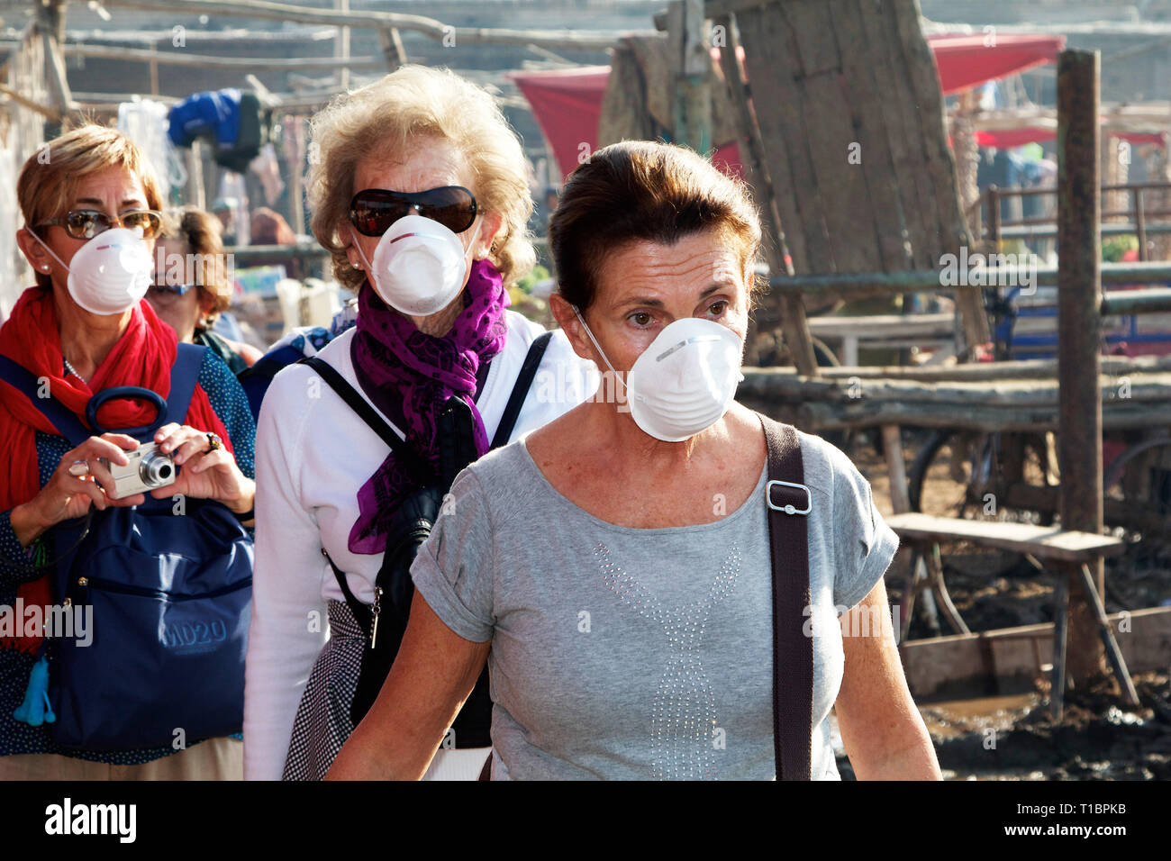 A foreign tourist wears a mask as a precaution at Kashgar Market ...