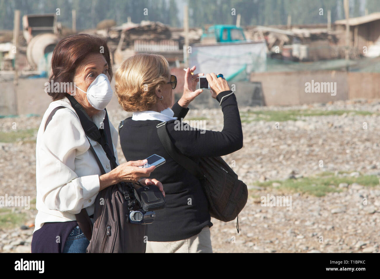A foreign tourist wears a mask as a precaution at Kashgar Market ...