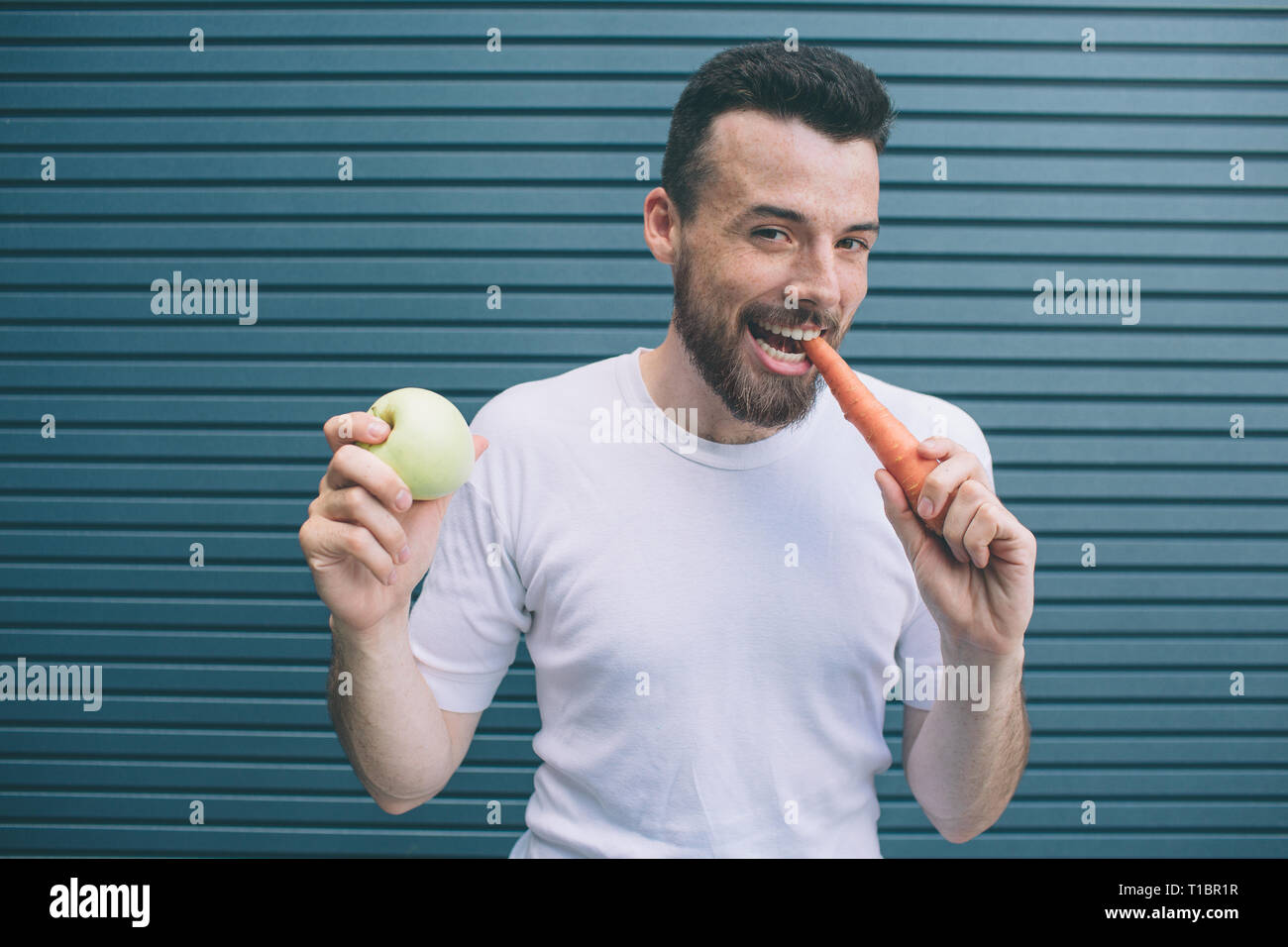 Man biting apple hi-res stock photography and images - Alamy