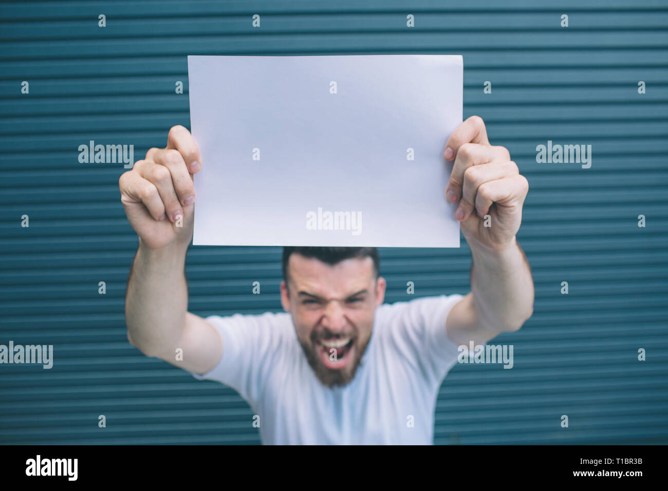 Strong guy is standing and screaming. He is yelling on camera. Man is ...