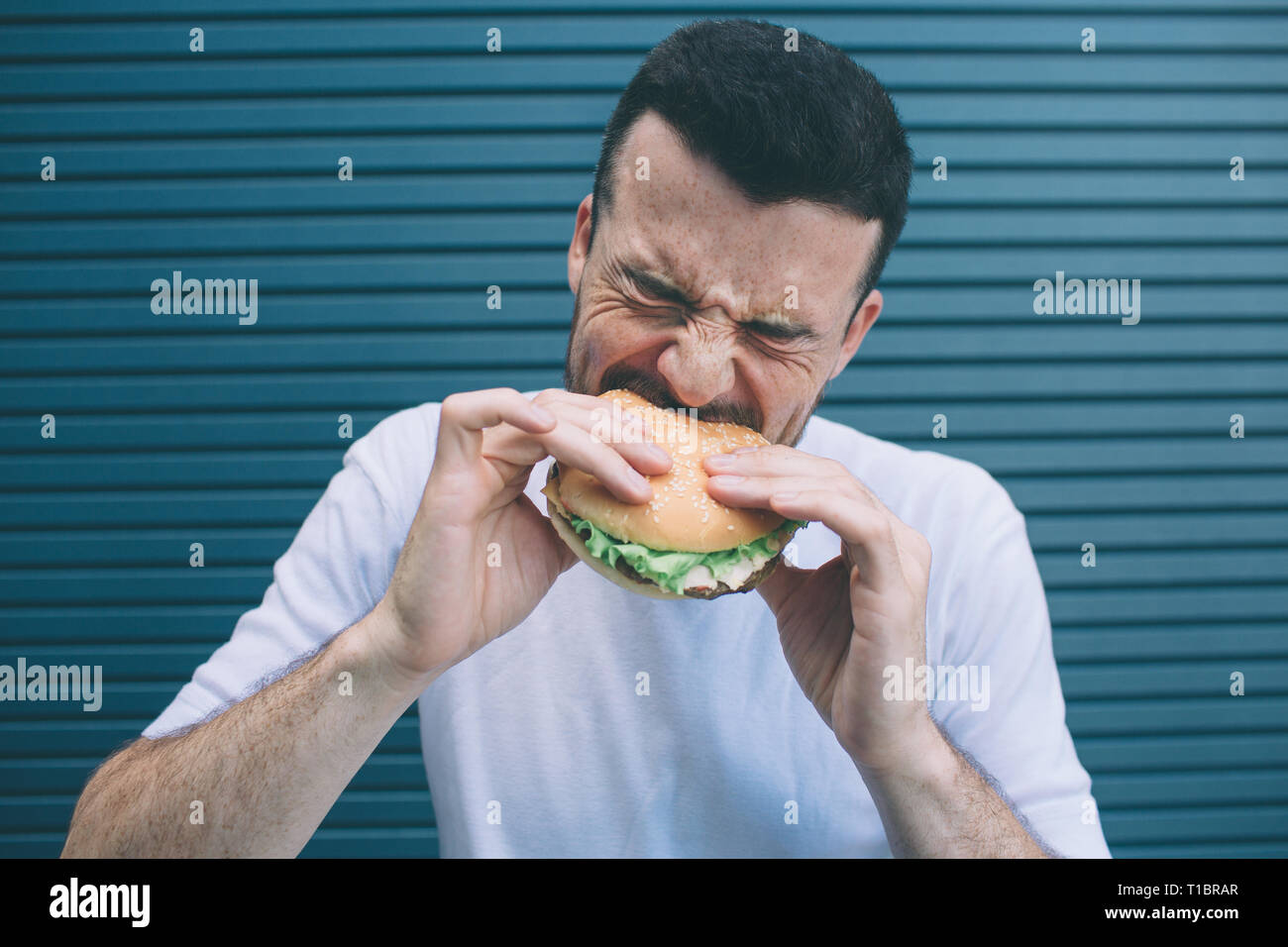 Biting into a burger hi-res stock photography and images - Alamy