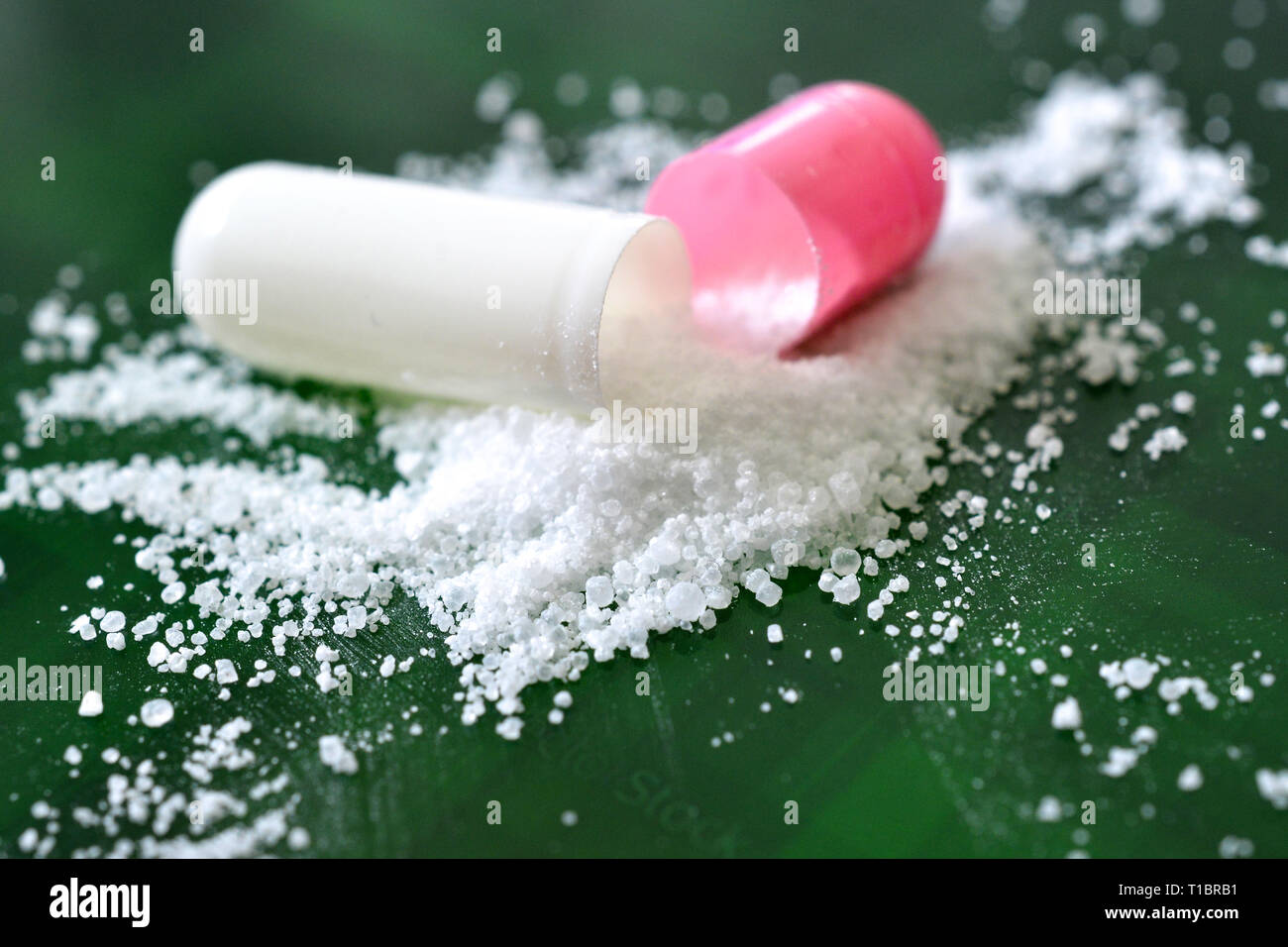 powder of an open capsule on a smartphone screen with logo of facebook ...