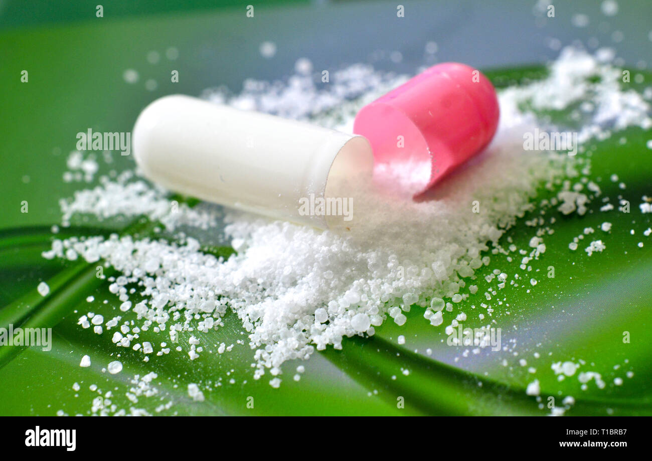 powder of an open capsule on a smartphone screen with logo of facebook ...