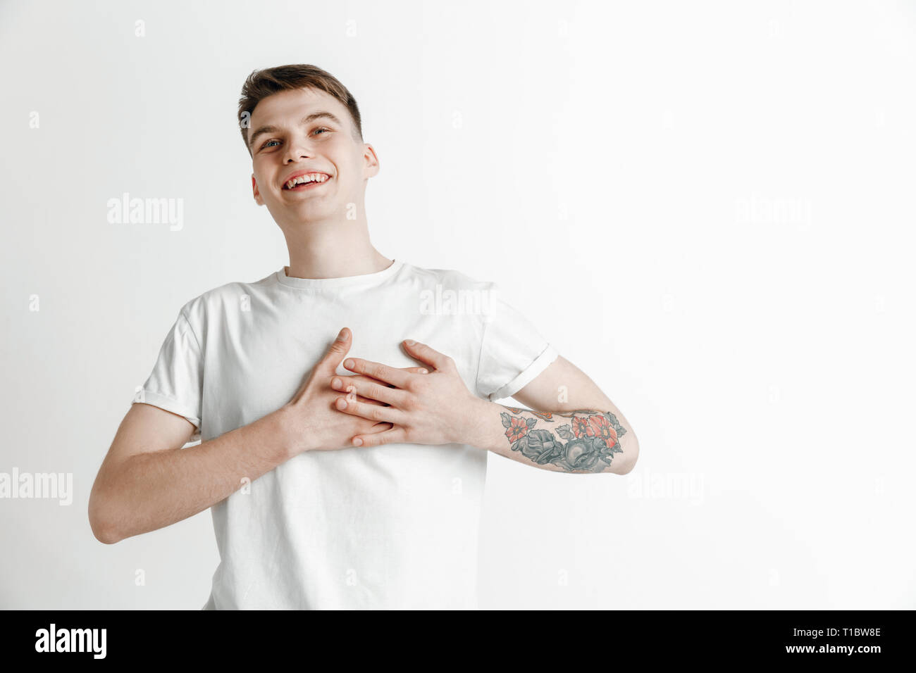 Happy business man standing, smiling isolated on gray studio background ...