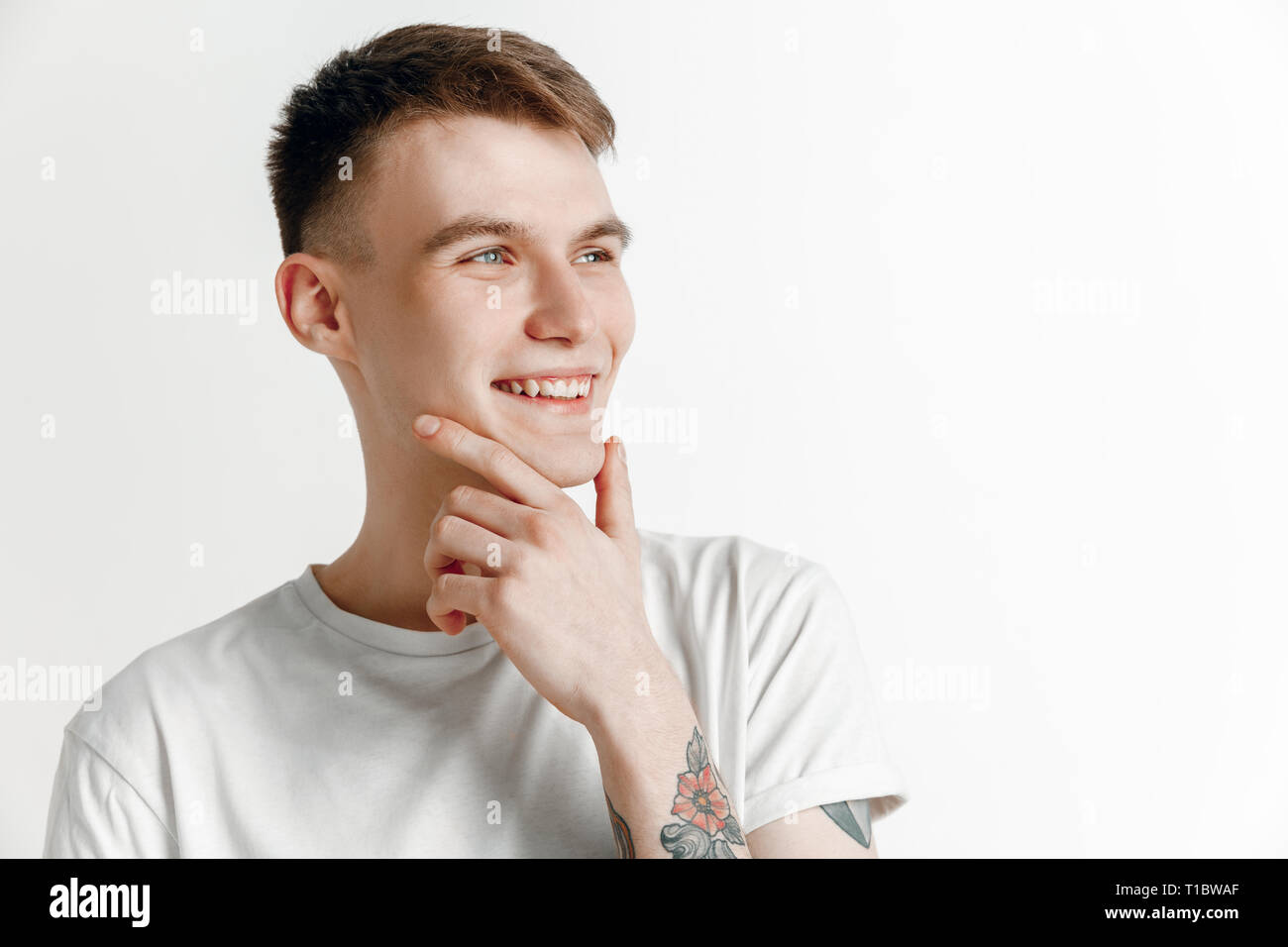 Happy business man standing, smiling isolated on gray studio background ...