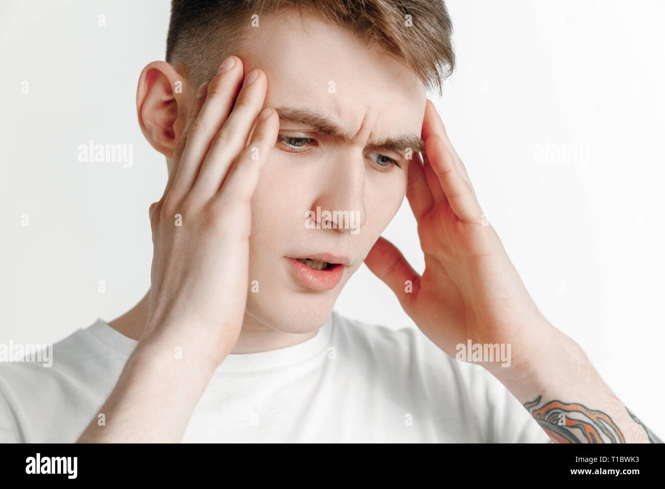 Man having headache. Business man standing with pain isolated on gray ...