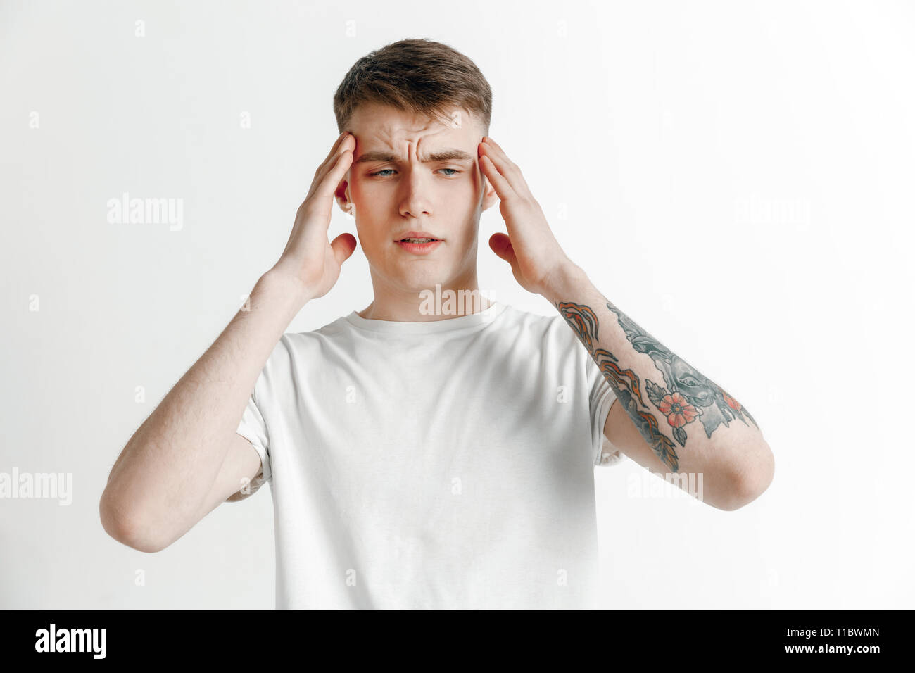 Man having headache. Business man standing with pain isolated on gray ...