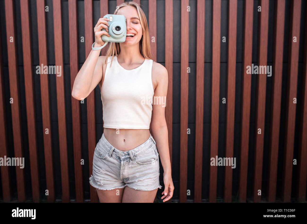 Positive and well-built girl is looking straight through camera lenz ...