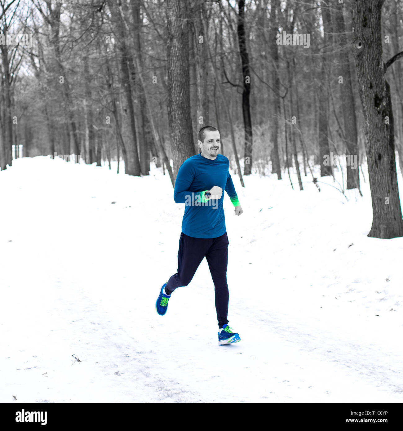 Adult man runner running in the forest in winter Stock Photo - Alamy