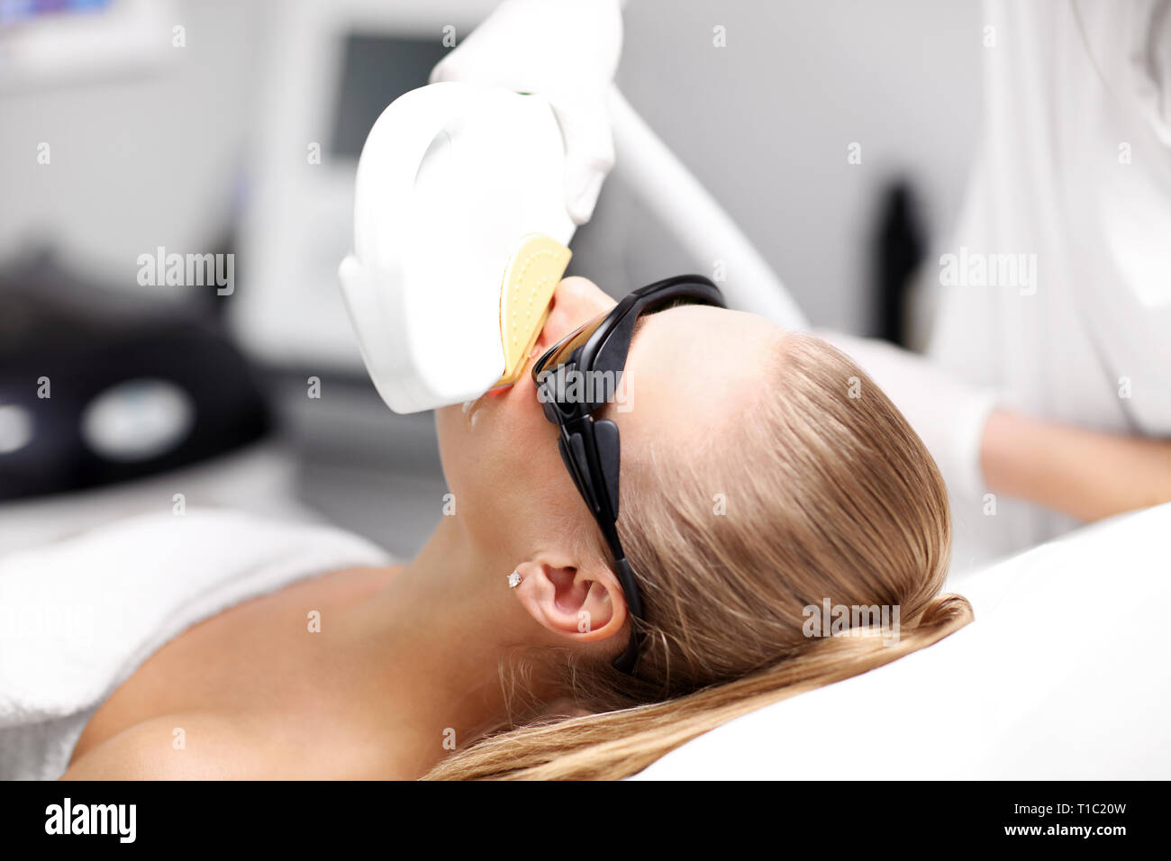 Picture Of Beautician Giving Epilation Laser Treatment To Woman On Face ...