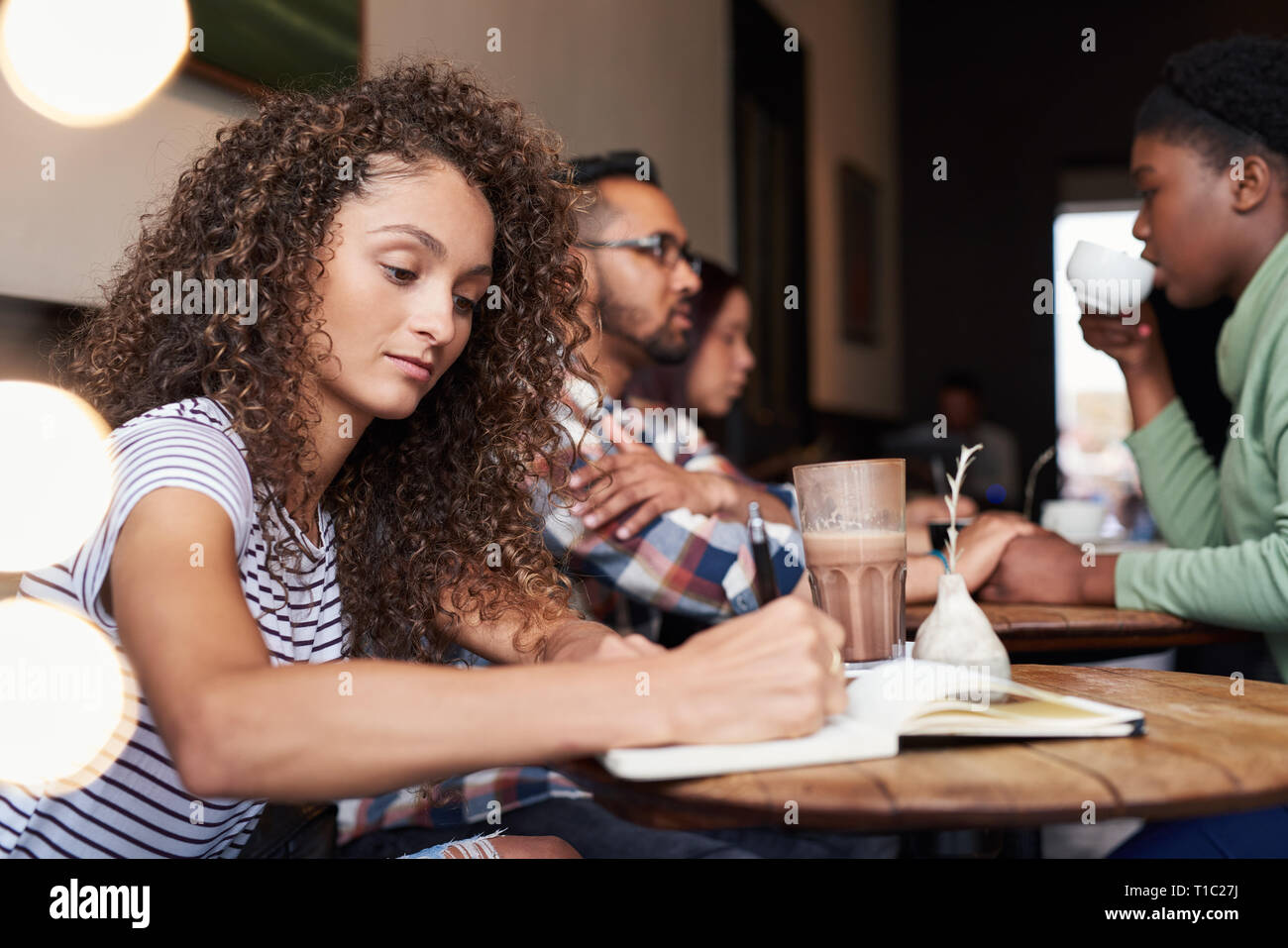 People sitting down enjoying a coffee hi-res stock photography and ...