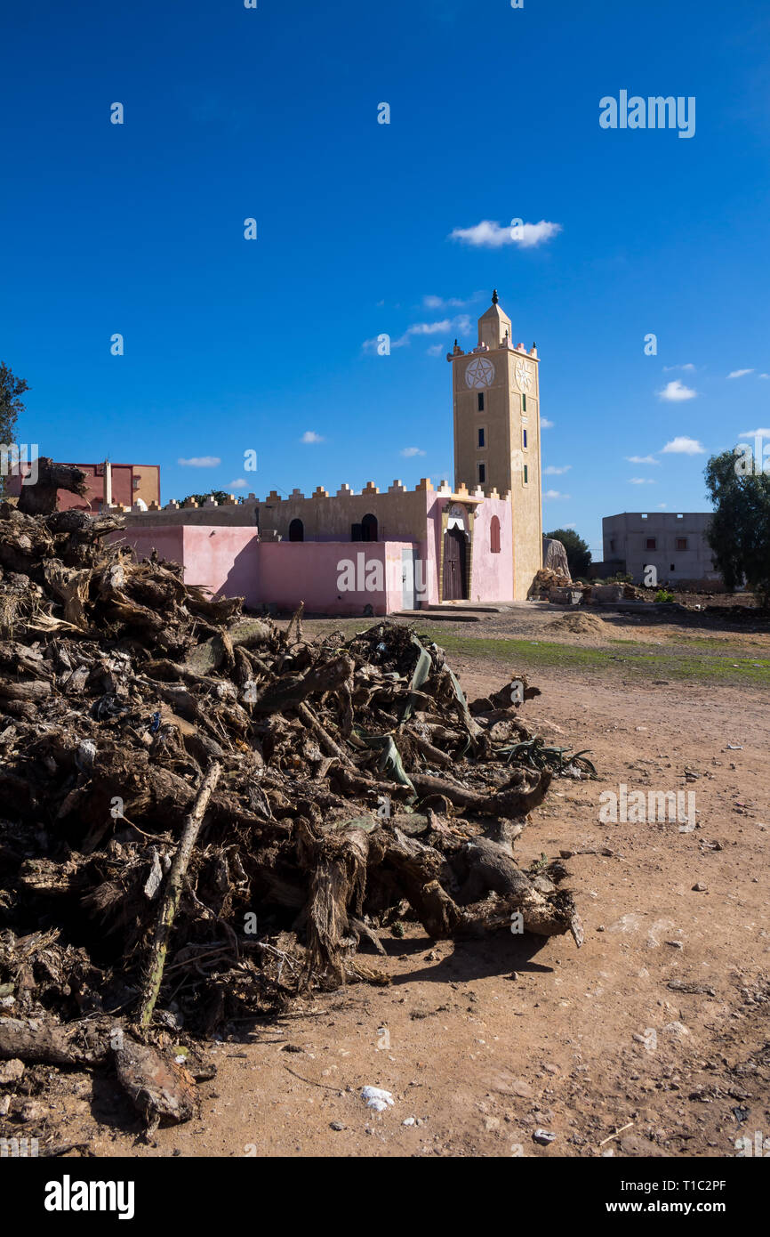 Pile of various natural pieces of a wood. Mosque with new facade in the ...