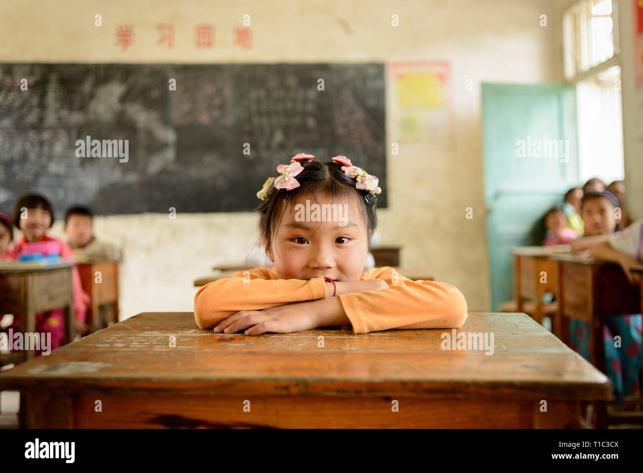 Elementary age school children attending class in a rural classroom in ...