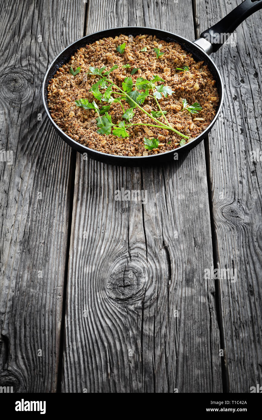 ground liver with onion and spices fried in a skillet, vertical view ...
